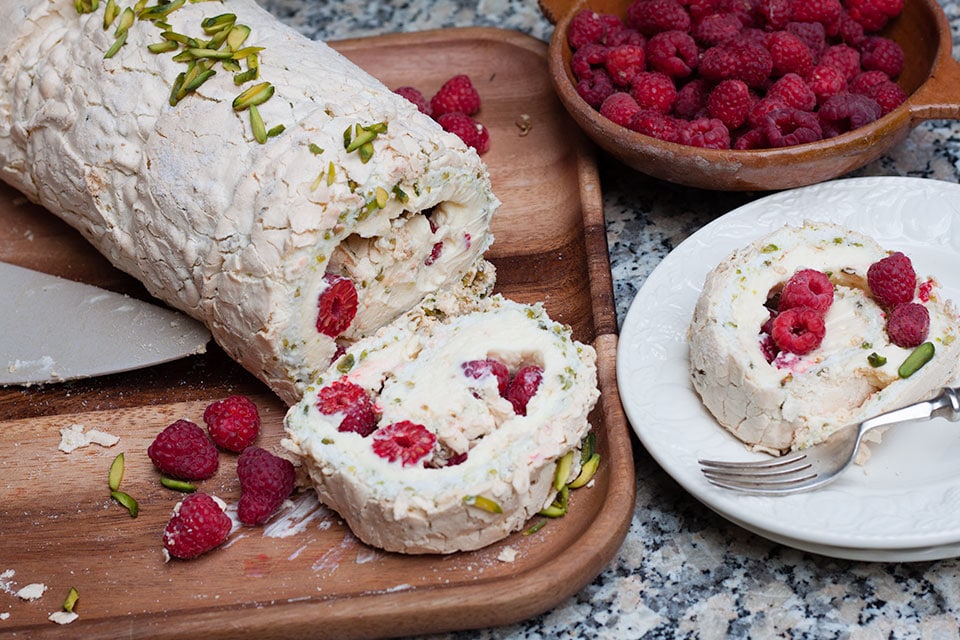 Pistachio, raspberry and lemon meringue roll | Recipes Made Easy